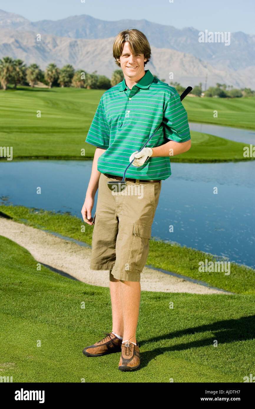 Golfer standing on golf course green, (portrait Stock Photo - Alamy