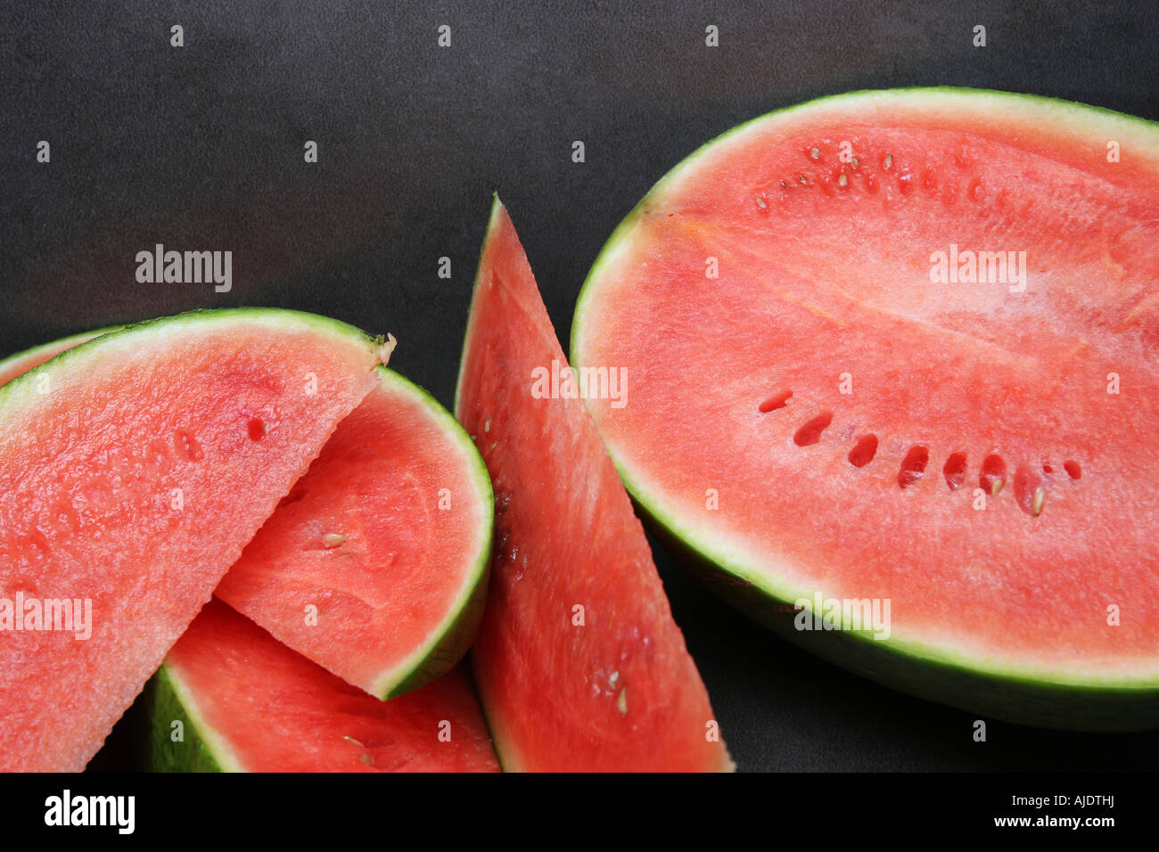 cut watermelon on a darkgrey background Stock Photo - Alamy