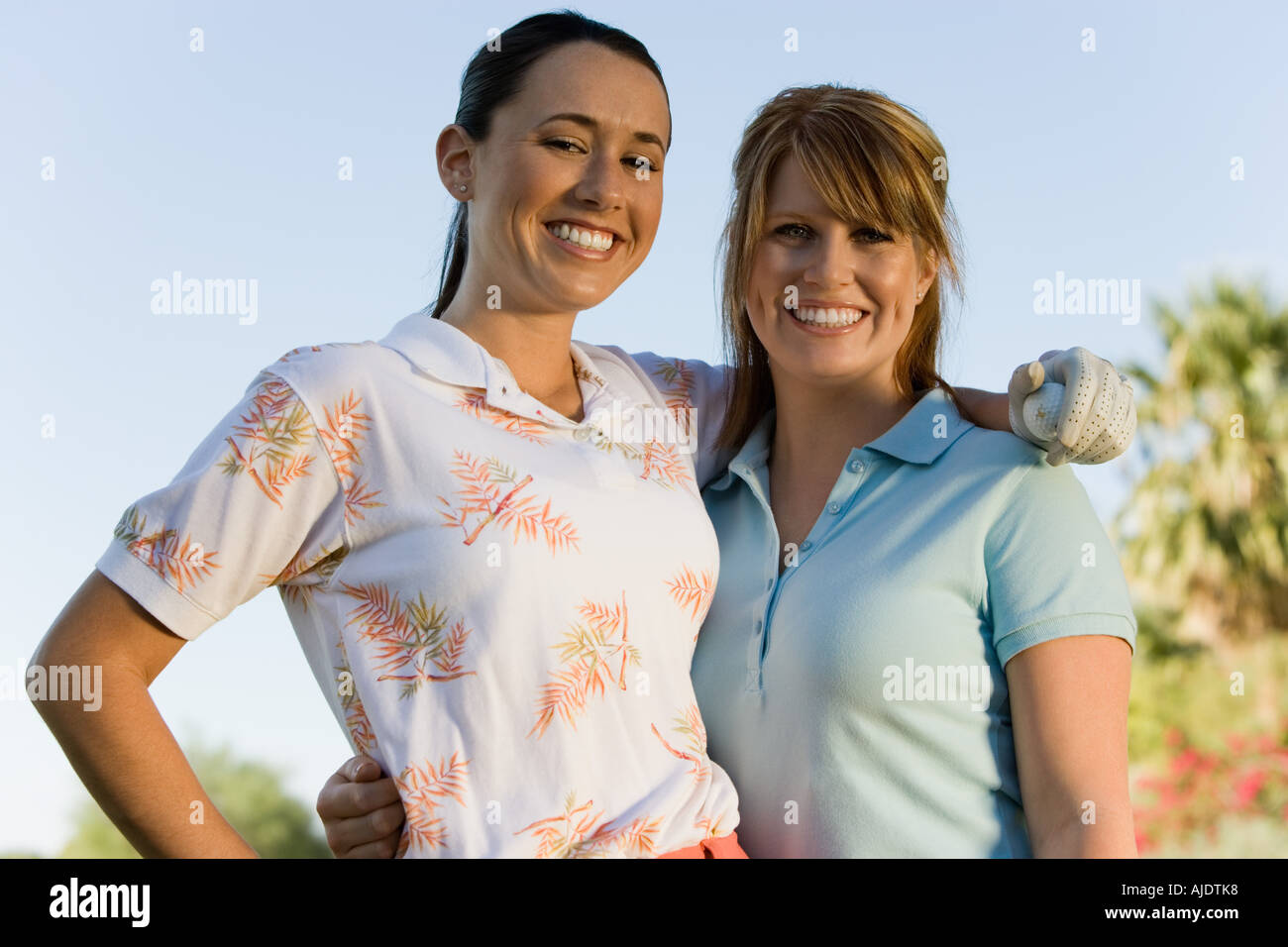 Two female golfers embracing, (portrait Stock Photo - Alamy