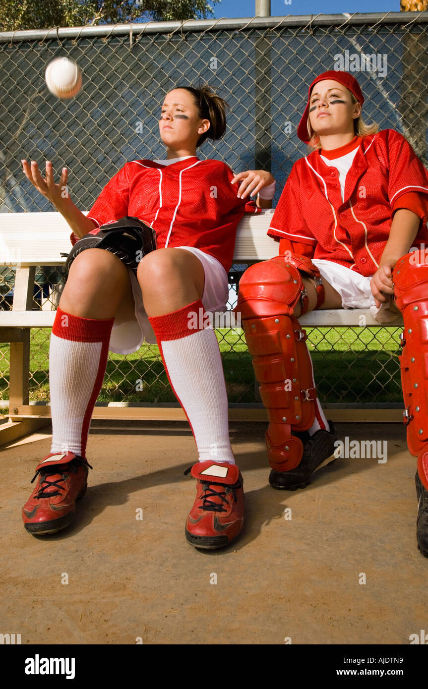Softball players sitting on bench, low angle view Stock Photo - Alamy