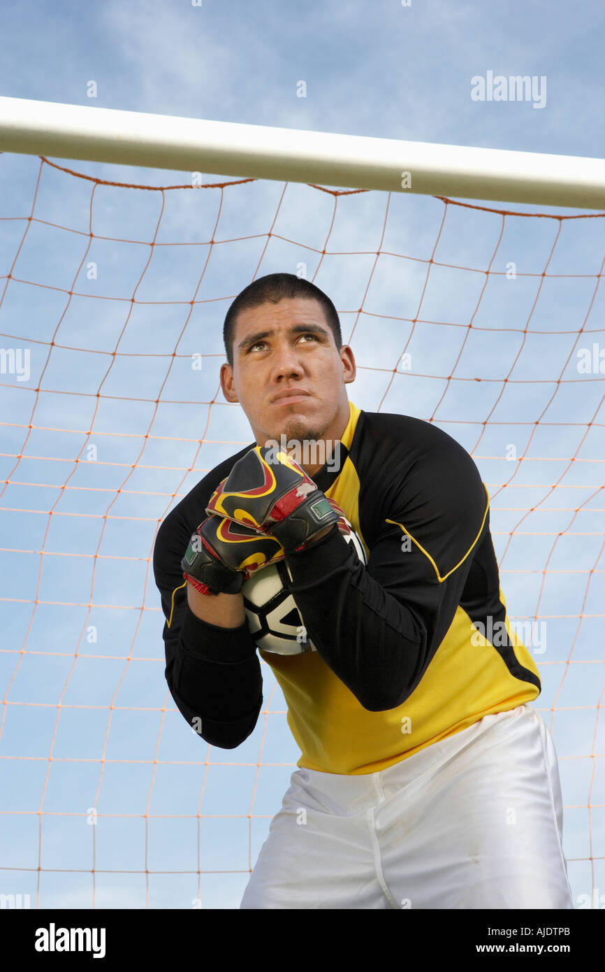 Goalkeeper holding ball, portrait Stock Photo - Alamy