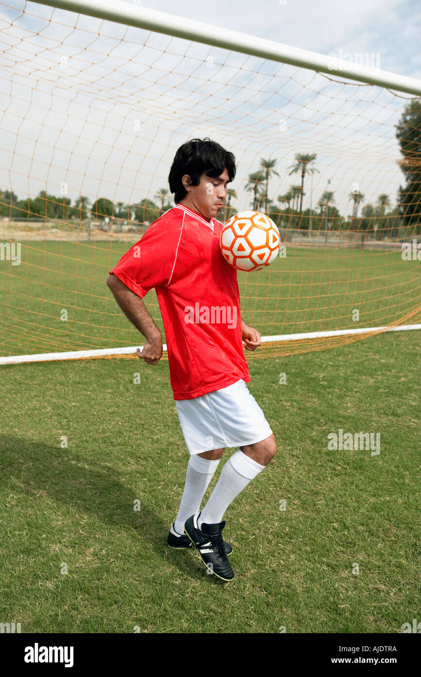 Soccer player juggling ball, portrait Stock Photo - Alamy