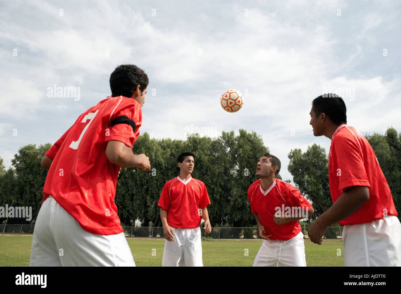 Soccer players practising heading ball Stock Photo - Alamy