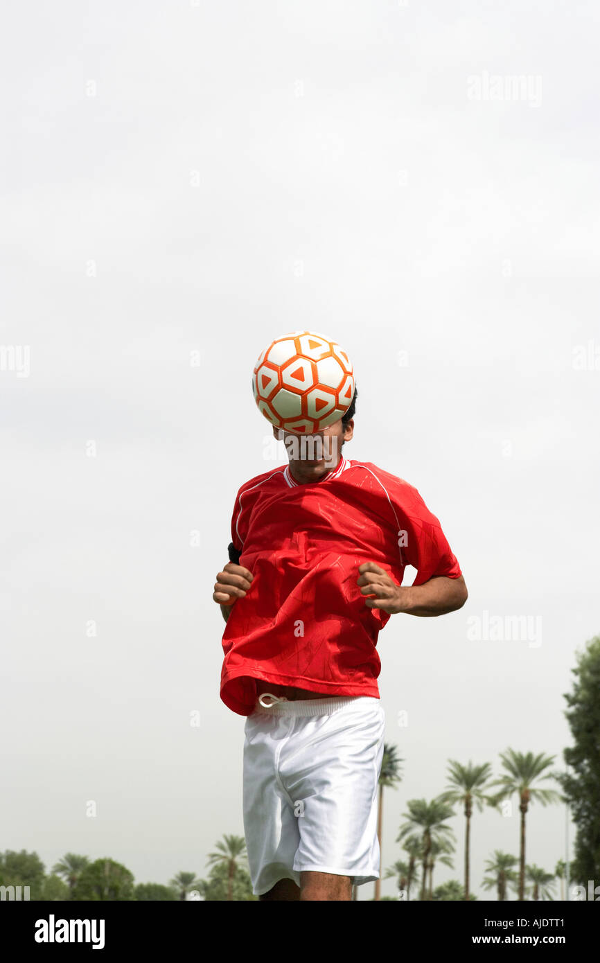 Soccer player heading ball, portrait Stock Photo - Alamy