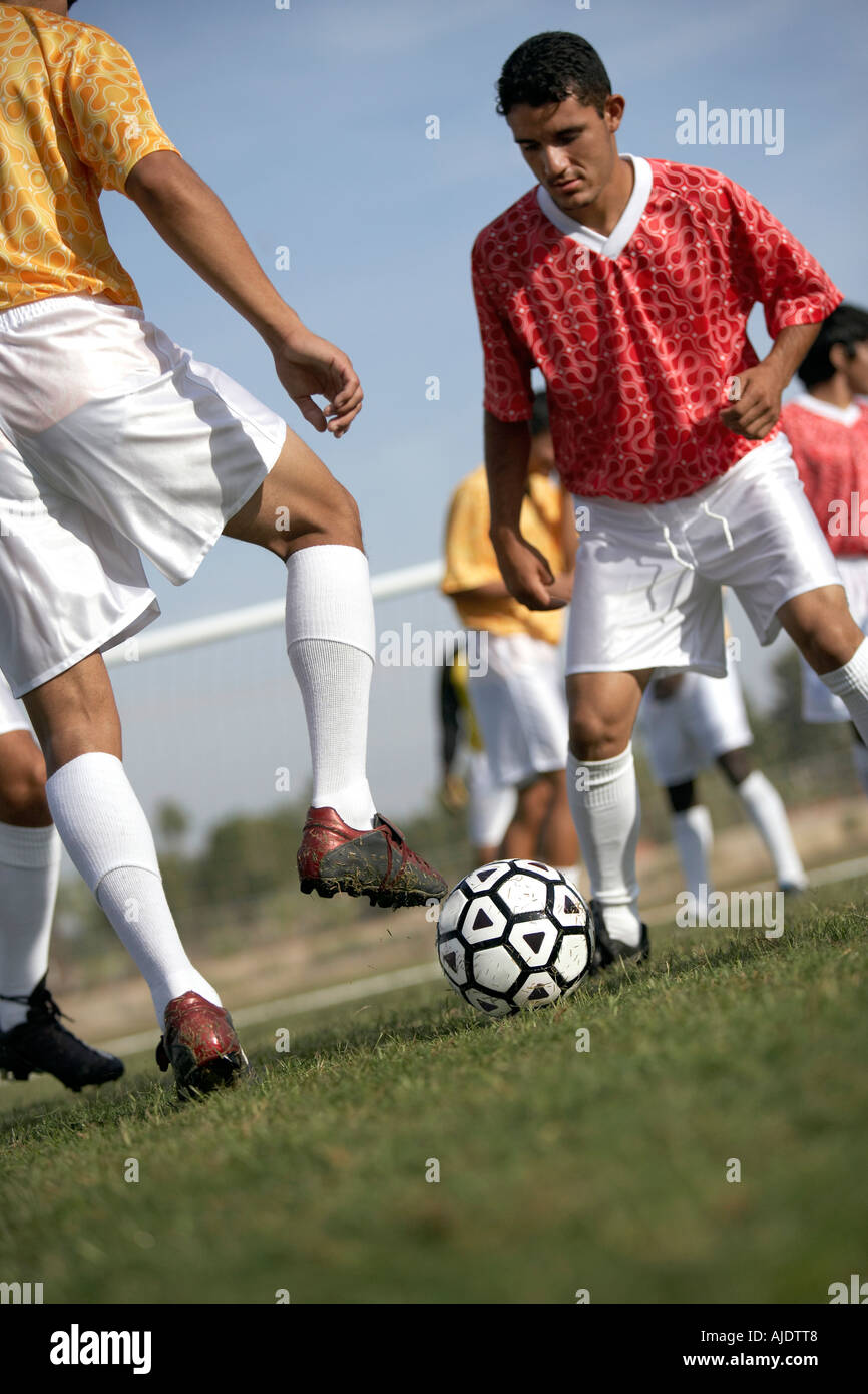 Soccer players competing for ball Stock Photo - Alamy