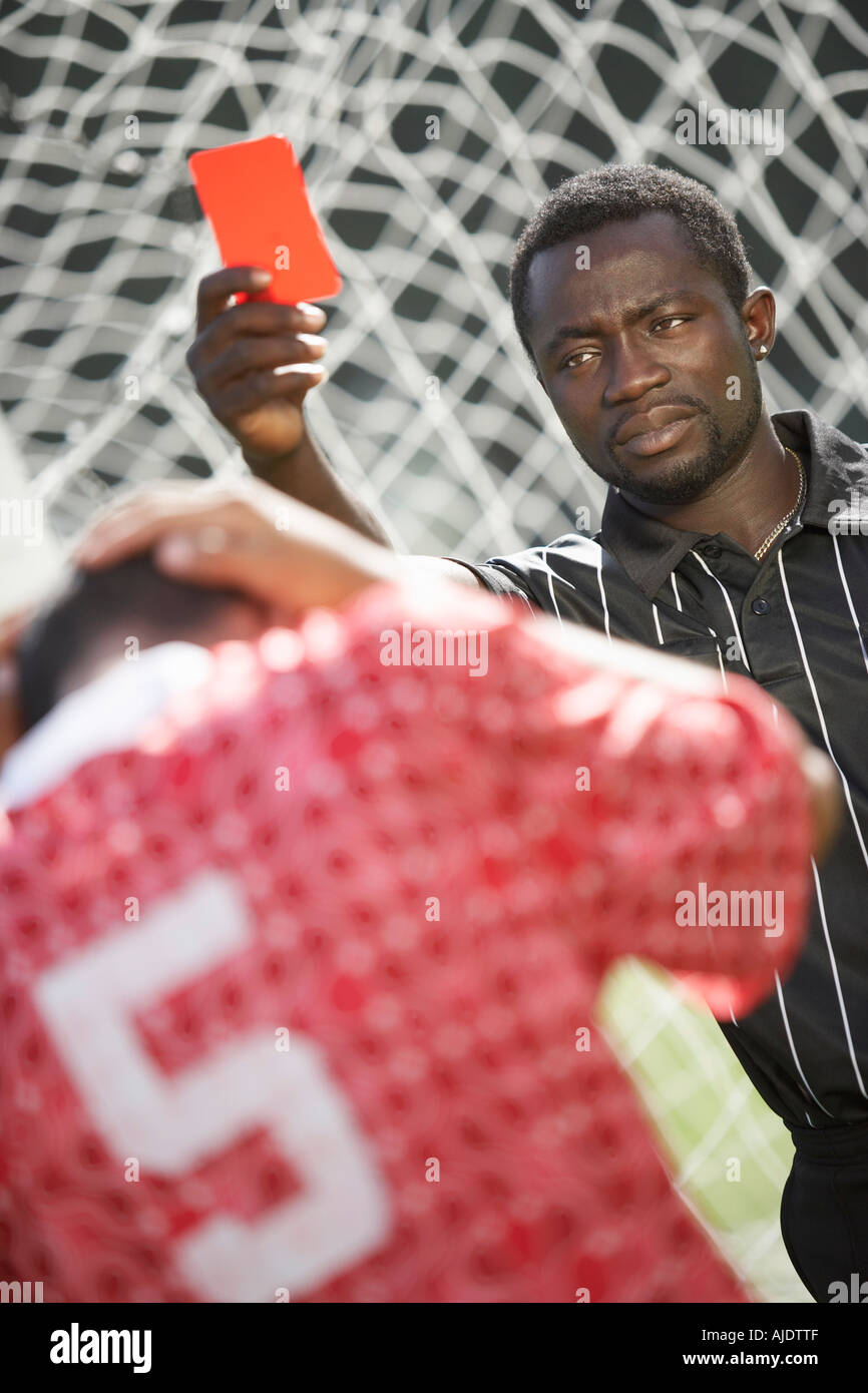 Soccer referee holding out red card, portrait Stock Photo - Alamy