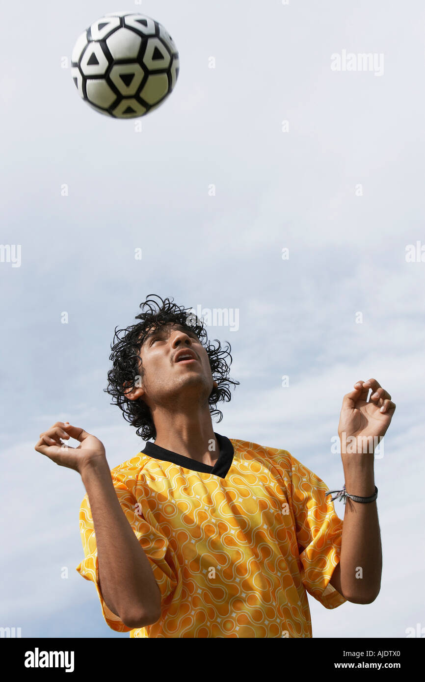 Soccer player heading ball, portrait Stock Photo - Alamy