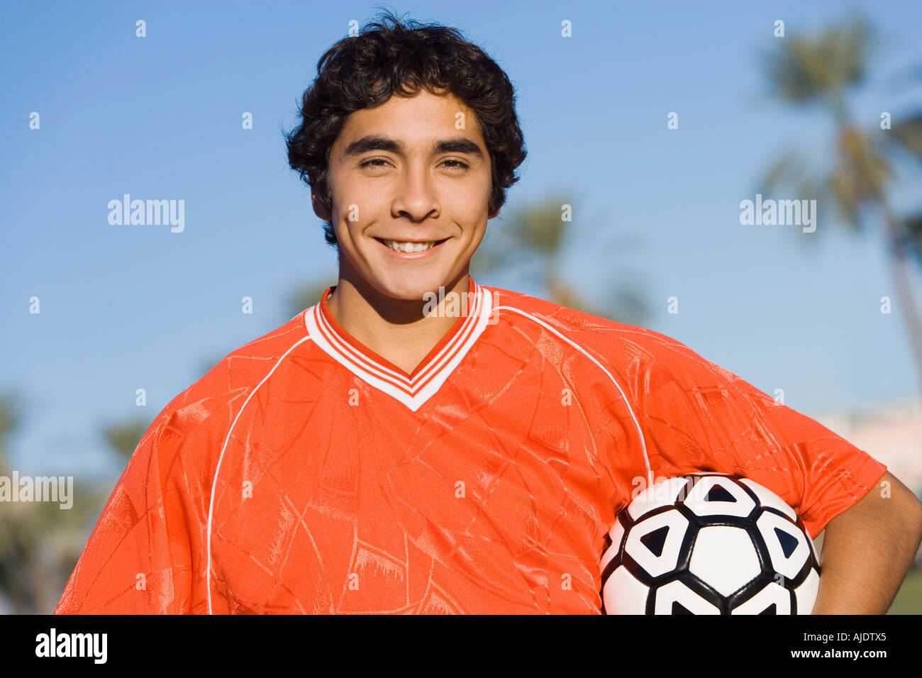 Soccer player holding ball, portrait Stock Photo - Alamy