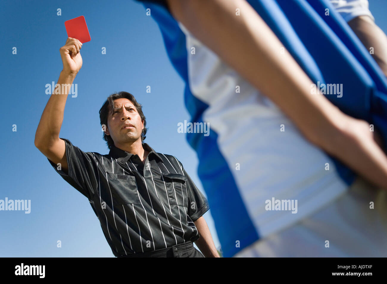 Referee holding up red card, portrait, low angle view Stock Photo - Alamy