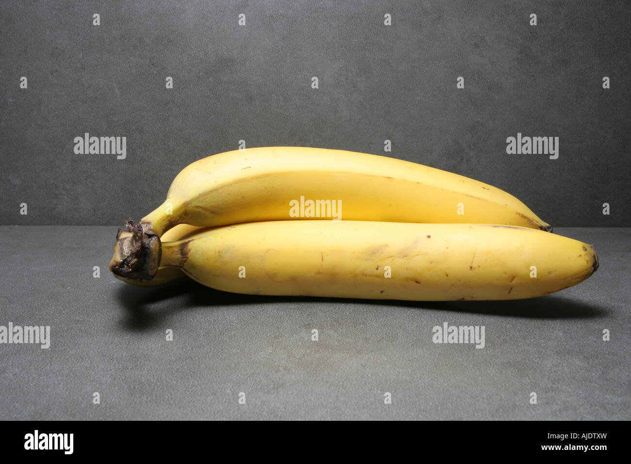 Bananas on grey tiles Stock Photo - Alamy