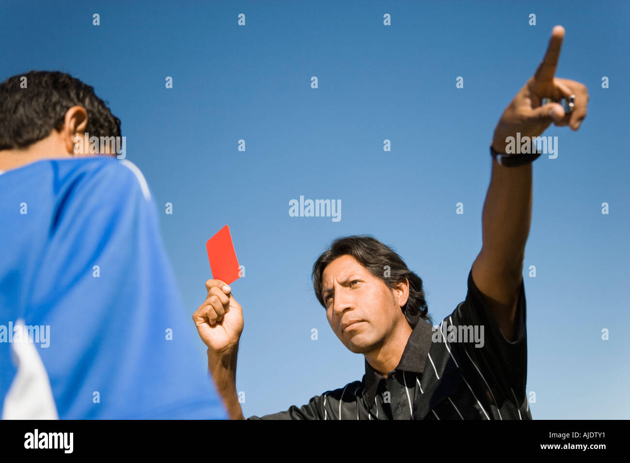 Referee holding up red card and pointing, portrait Stock Photo - Alamy