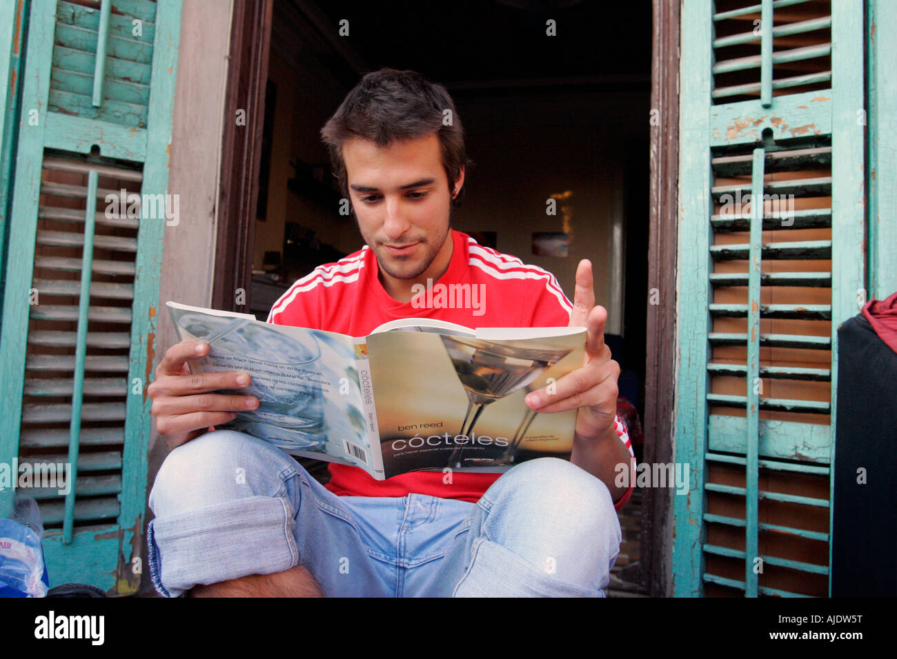 Young man reading a cocktails book Stock Photo - Alamy