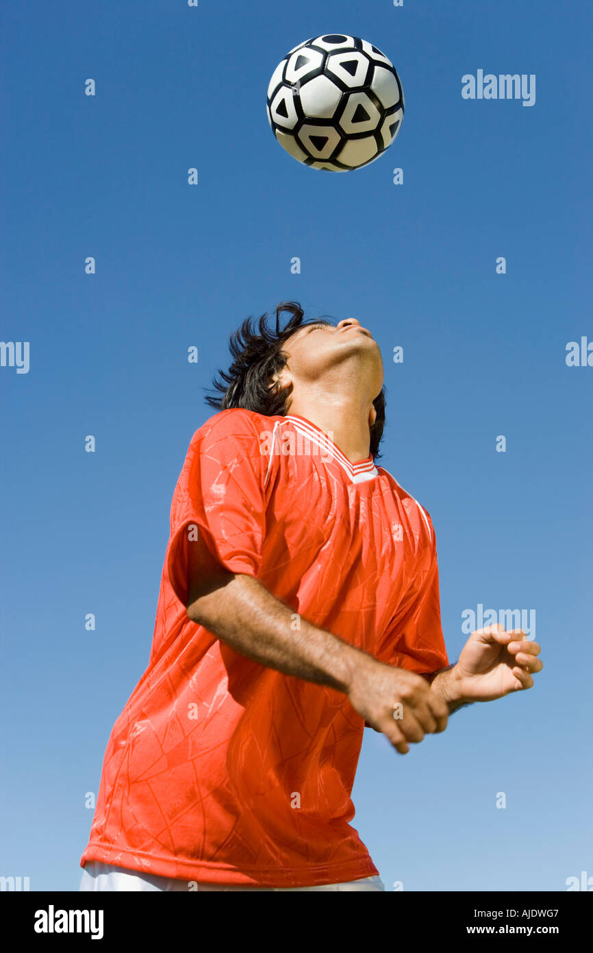 Soccer player heading ball, portrait Stock Photo - Alamy