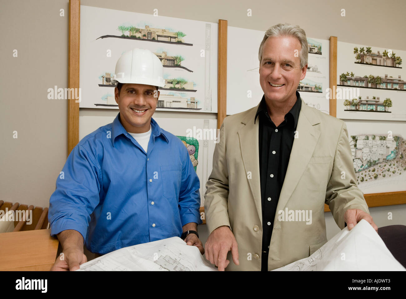 Builder and architect discussing blueprint, portrait Stock Photo - Alamy
