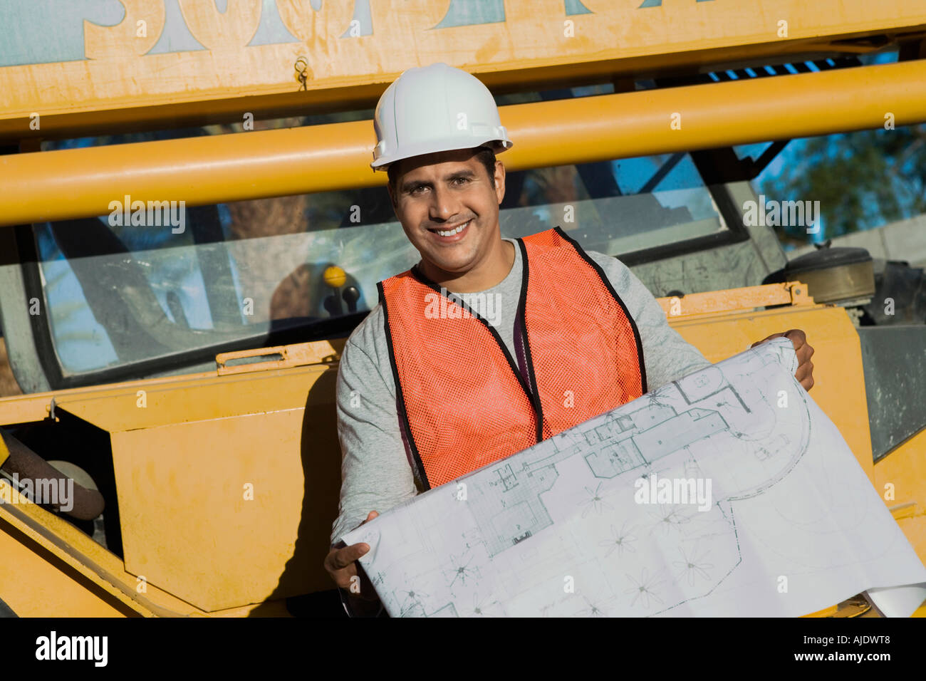 Builder with blueprint for new home, portrait Stock Photo - Alamy
