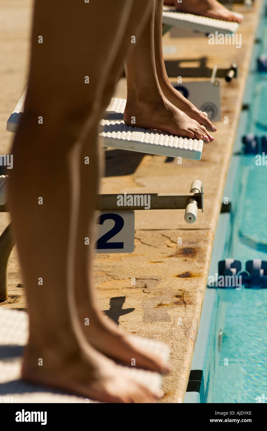 Female swimmers on starting blocks, (low section Stock Photo - Alamy