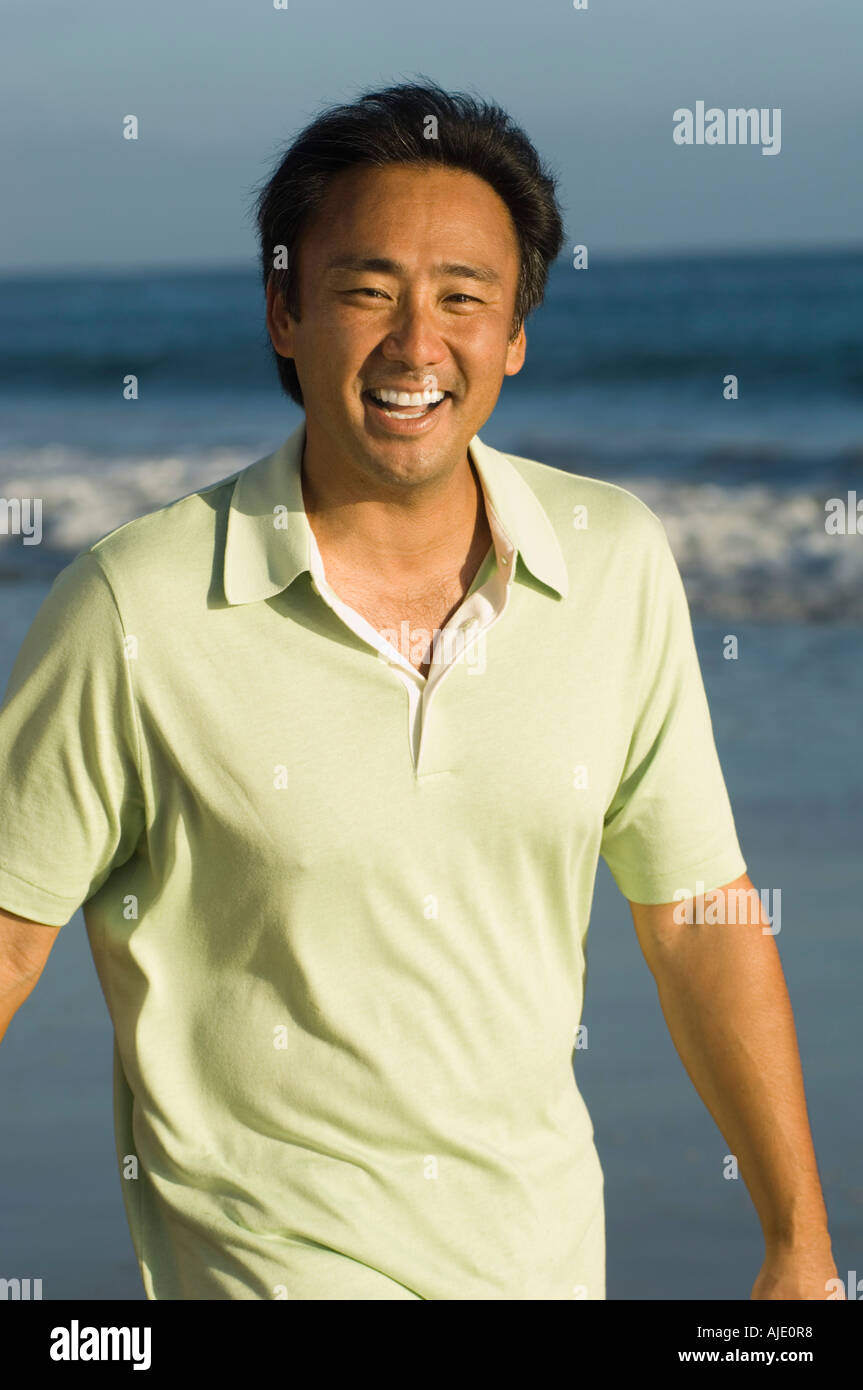 Man smiling on beach, (portrait Stock Photo - Alamy