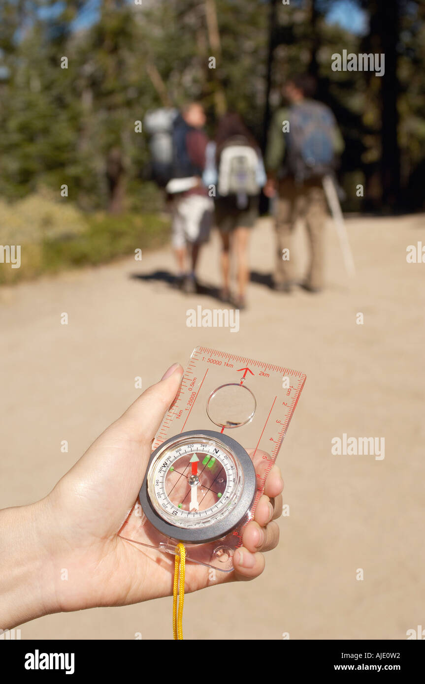 Hiker holding compass, outdoors Stock Photo - Alamy