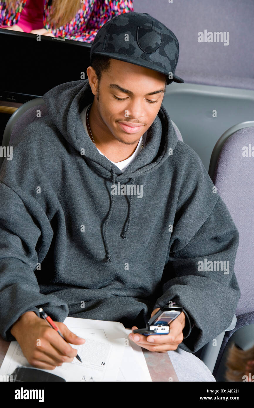 Student using mobile phone during class Stock Photo - Alamy