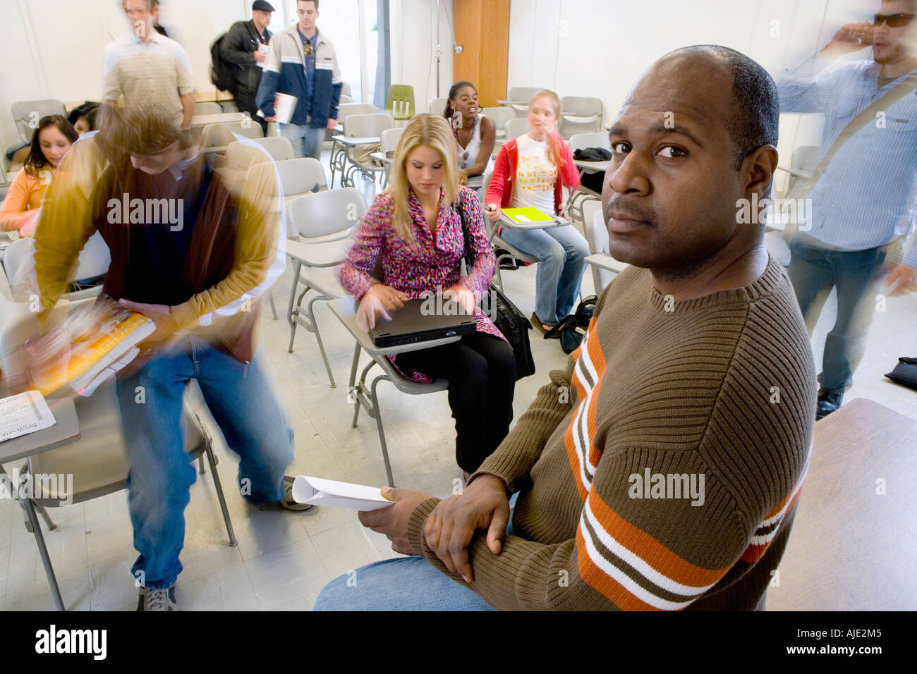 Teacher waiting for students in classroom, (portrait Stock Photo - Alamy