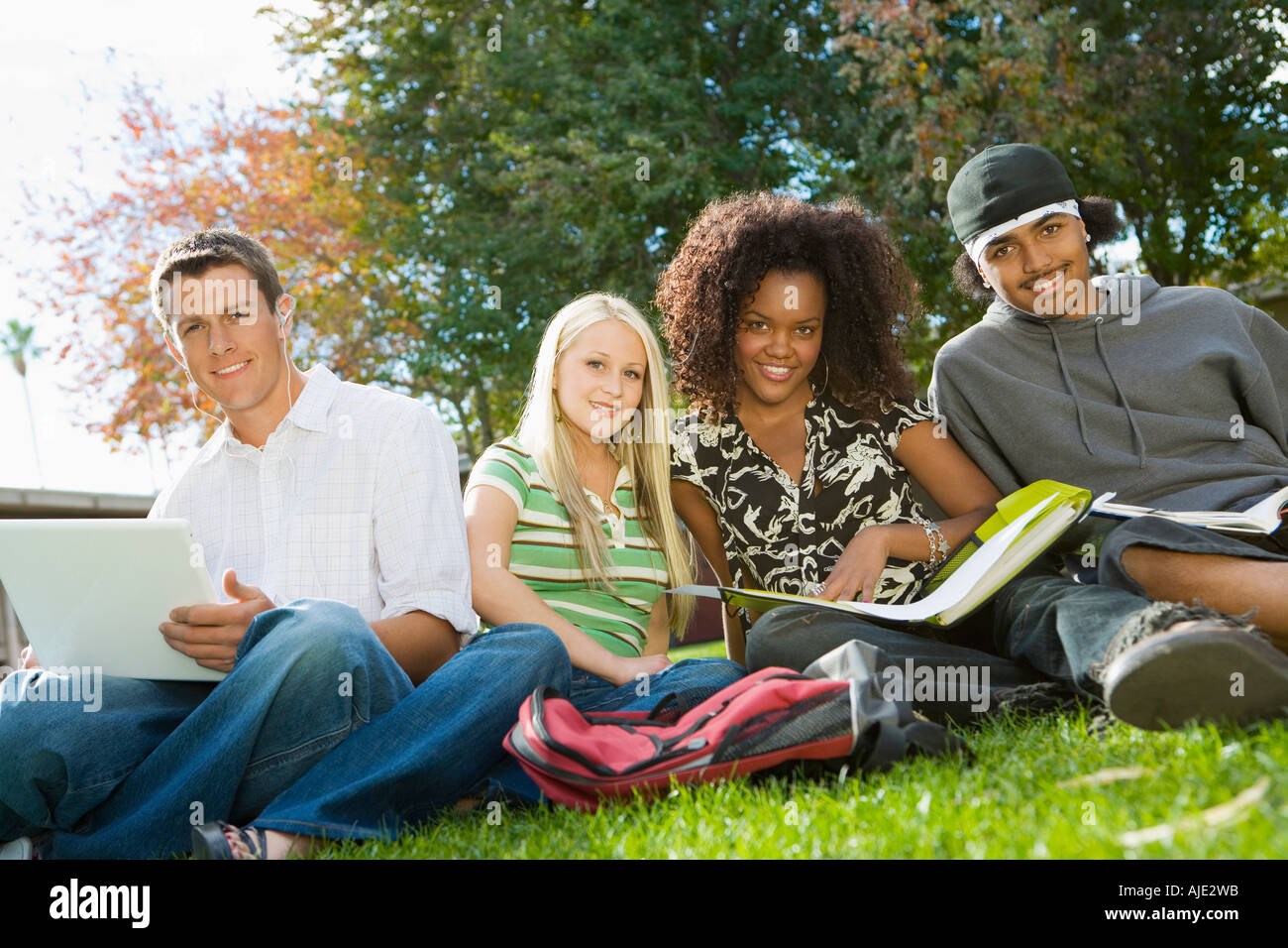 Four students studying outdoors, (portrait Stock Photo - Alamy