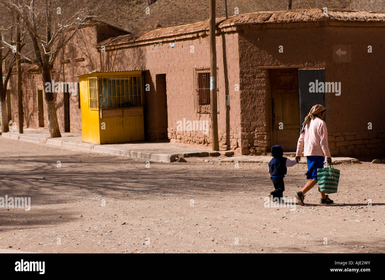 Colla woman and her kid walking in the town of Susques near the Andean ...