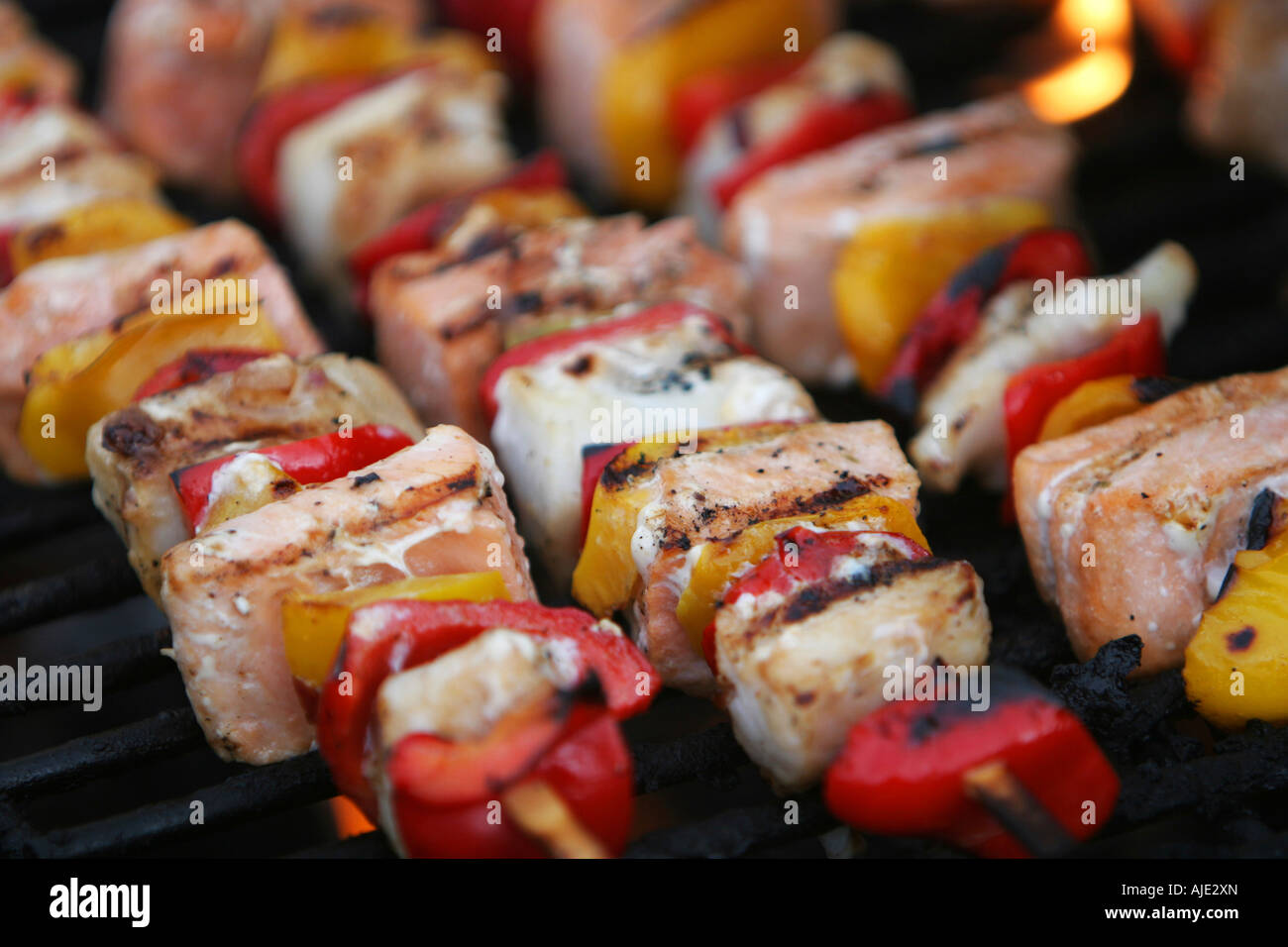 fresh fish on grilling sticks salmon and halibut with red and yellow ...