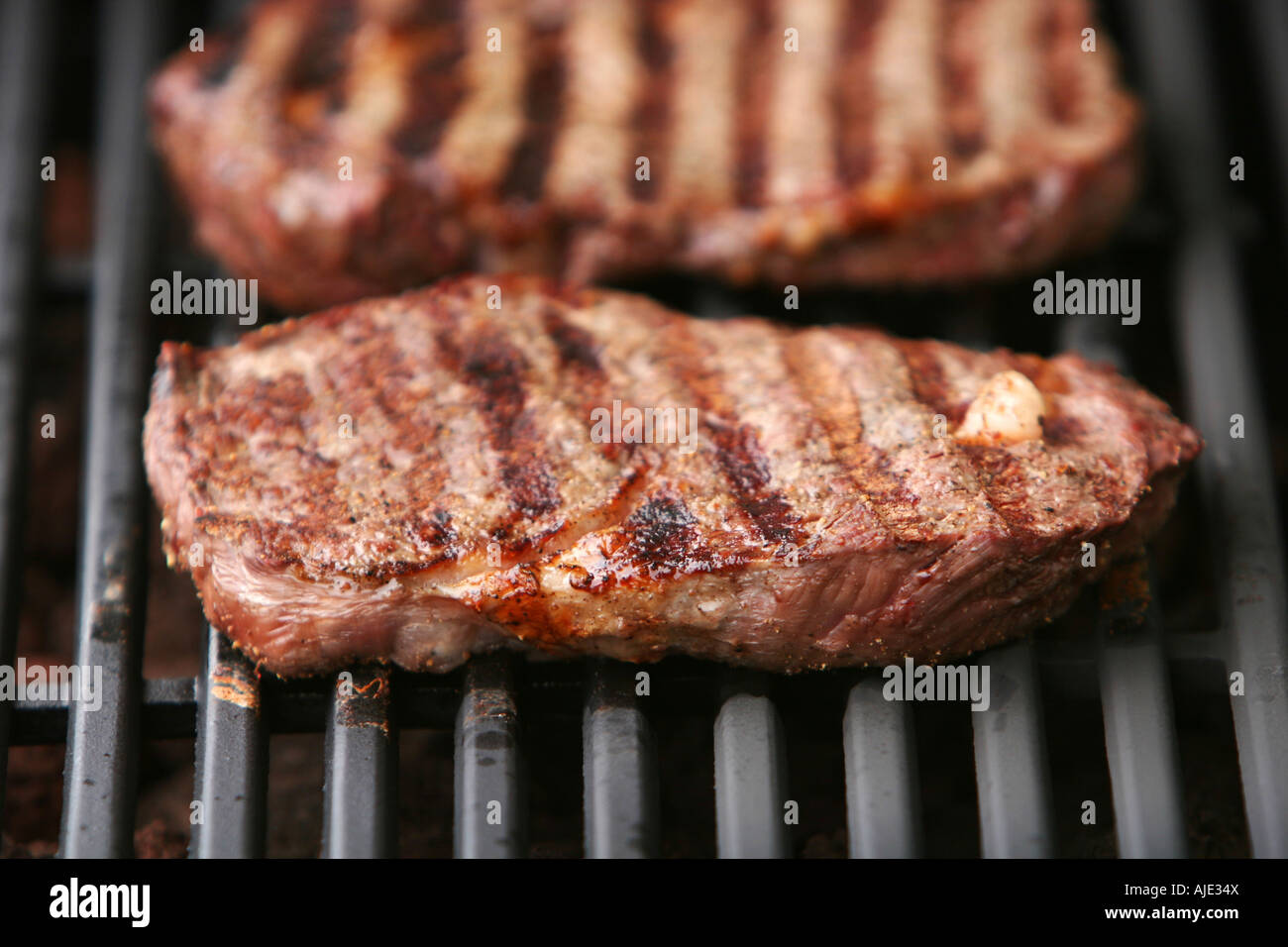 beef steak being grilled on a barbeque grill Stock Photo - Alamy