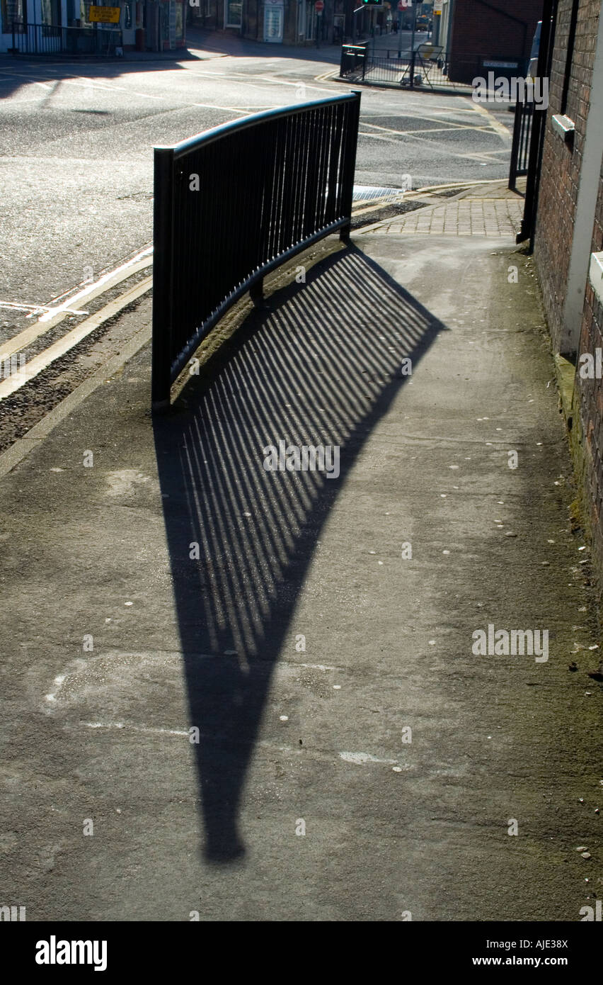 Shadows cast by a rail on a roadside, painting road Stock Photo - Alamy