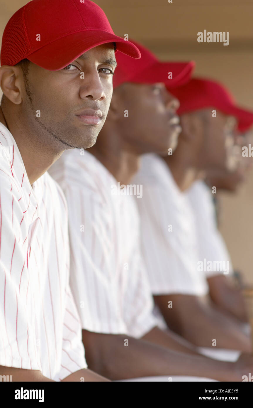 Baseball player sitting with team in dugout, (portrait Stock Photo - Alamy