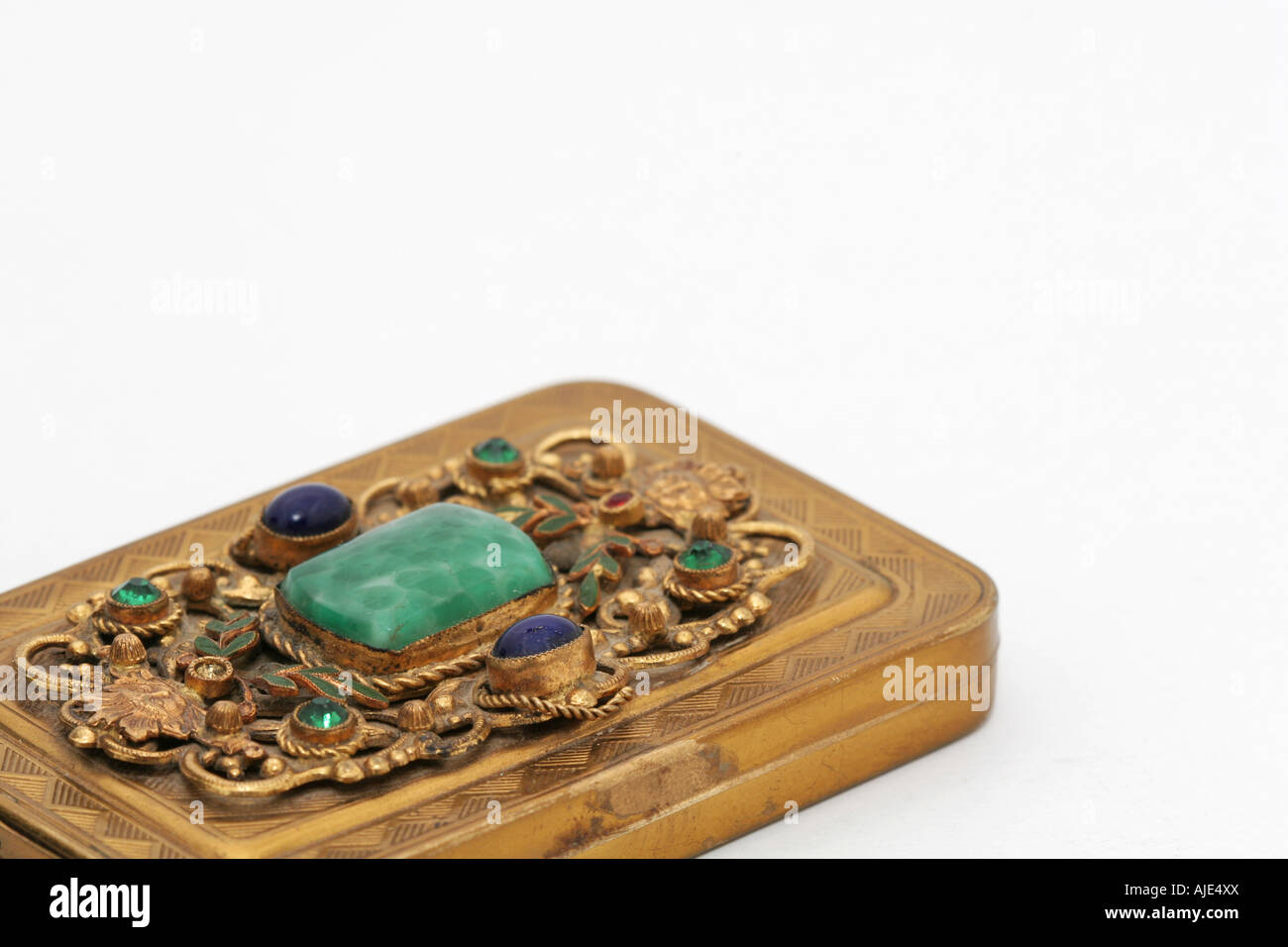 A close up of a gold jewel box with inlaid jewels isolated on white ...