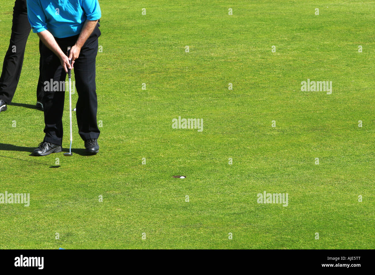 golfer putting the winning shot on a golf tournament golfball falling ...