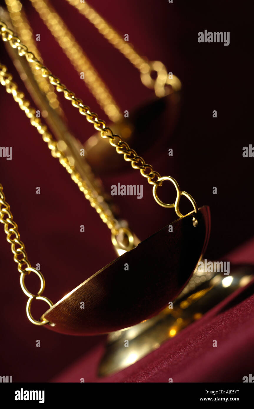 Shiny vintage justice scales on dark red background Stock Photo - Alamy