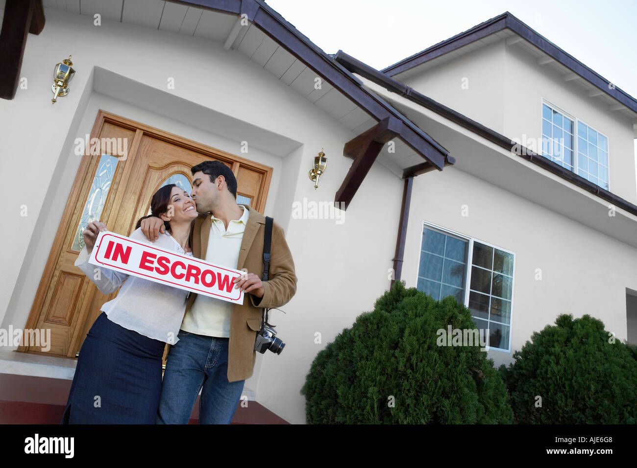 Homeowners standing in front of house, portrait Stock Photo - Alamy