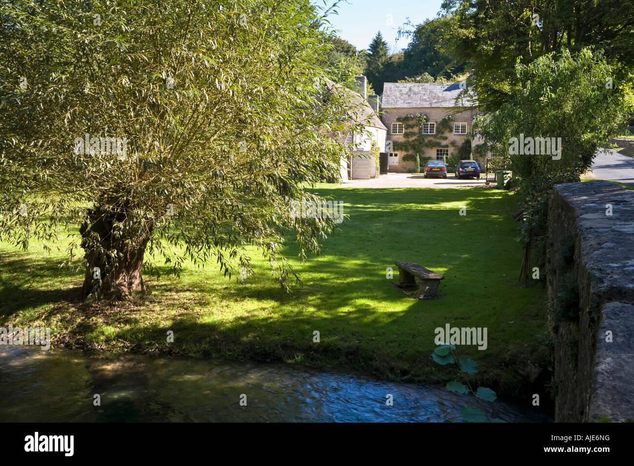 An old mill beside the River Churn in the Cotswold village of Rendcomb ...