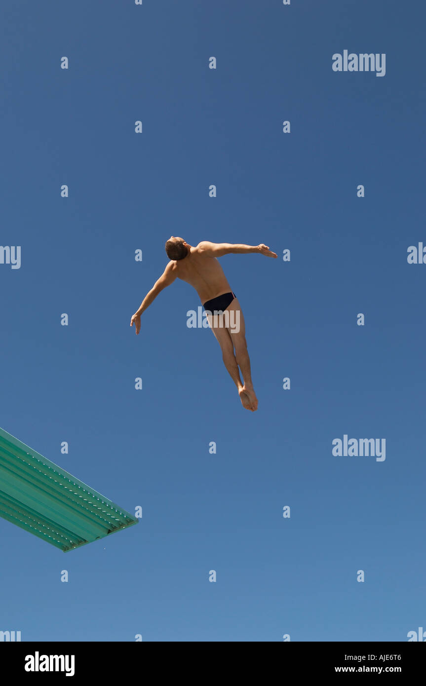 Man diving from diving board, mid air Stock Photo - Alamy