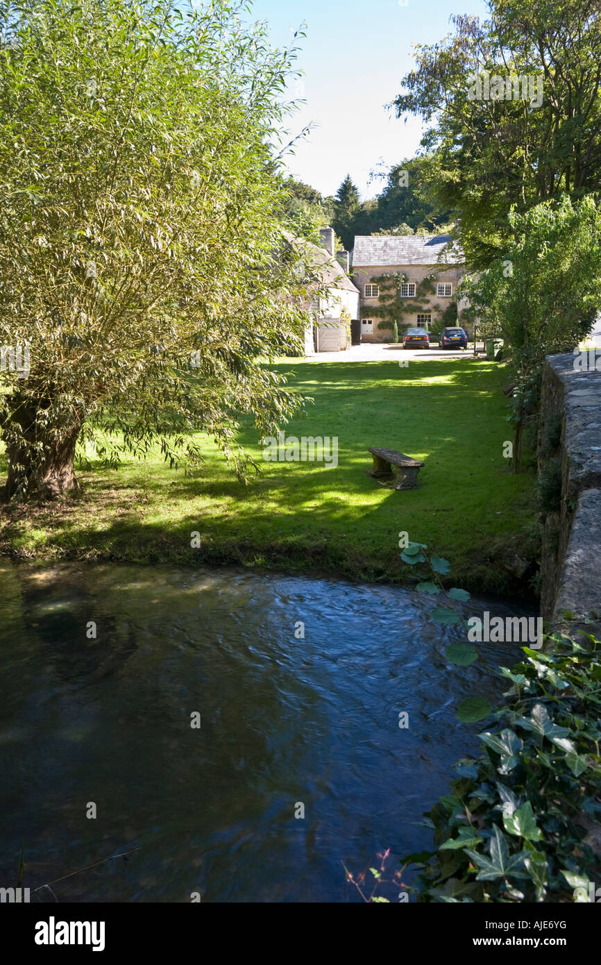 An old mill beside the River Churn in the Cotswold village of Rendcomb ...