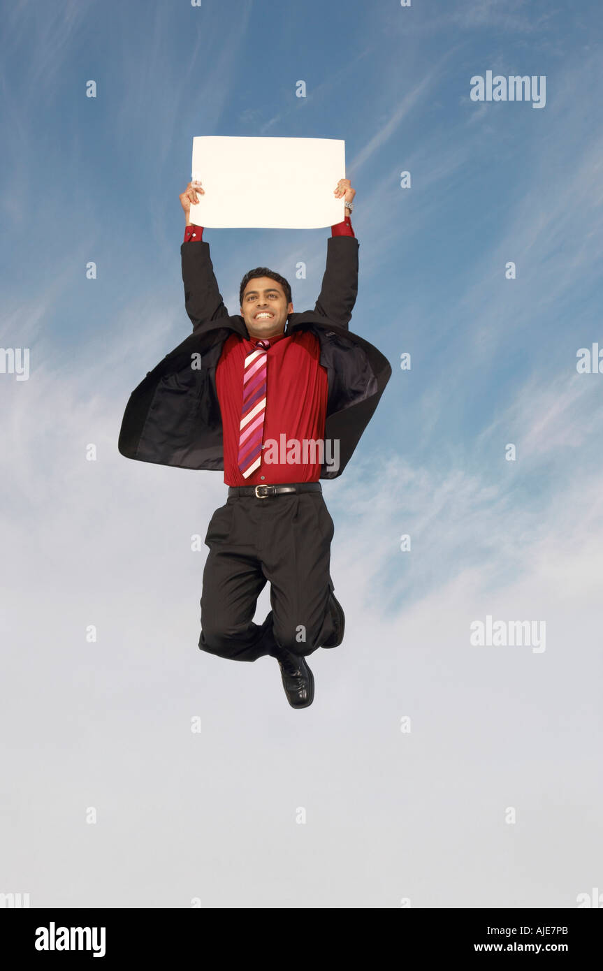 Business man jumping with blank sign outdoors Stock Photo - Alamy