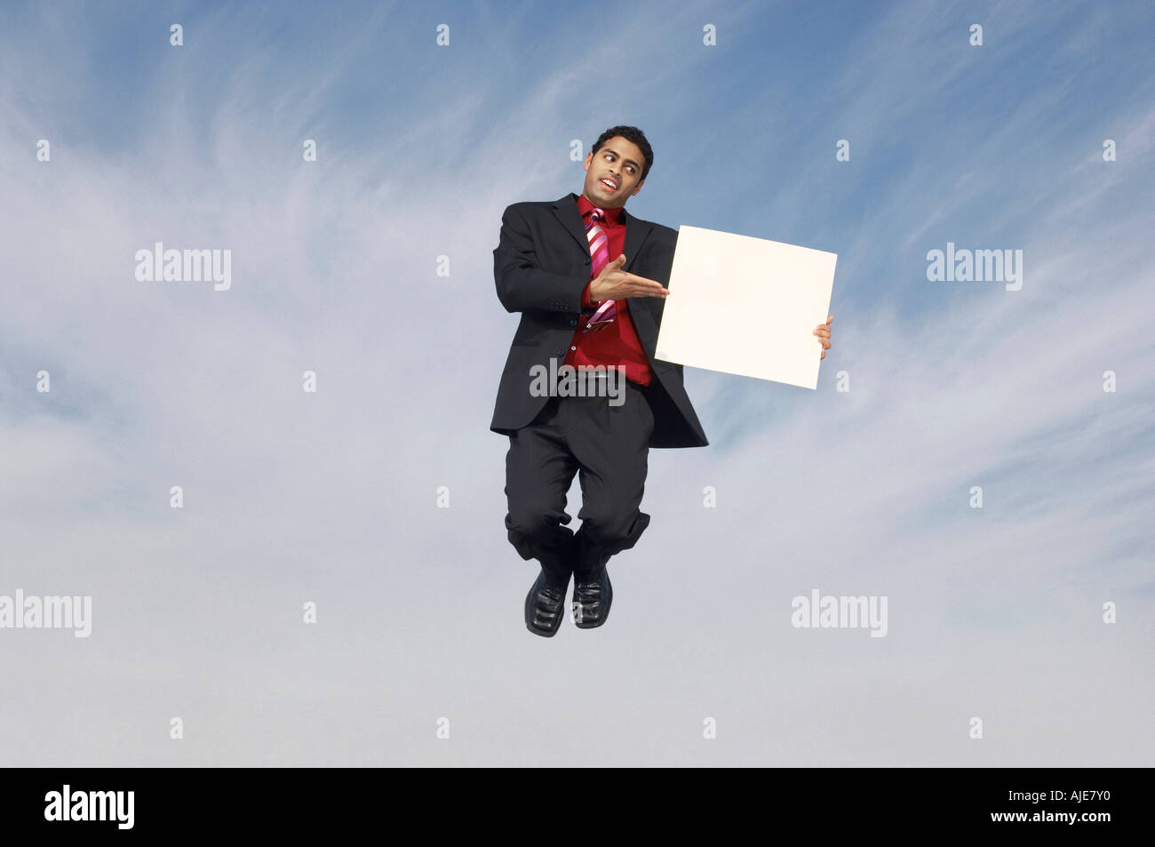 Business man jumping with blank sign outdoors Stock Photo - Alamy