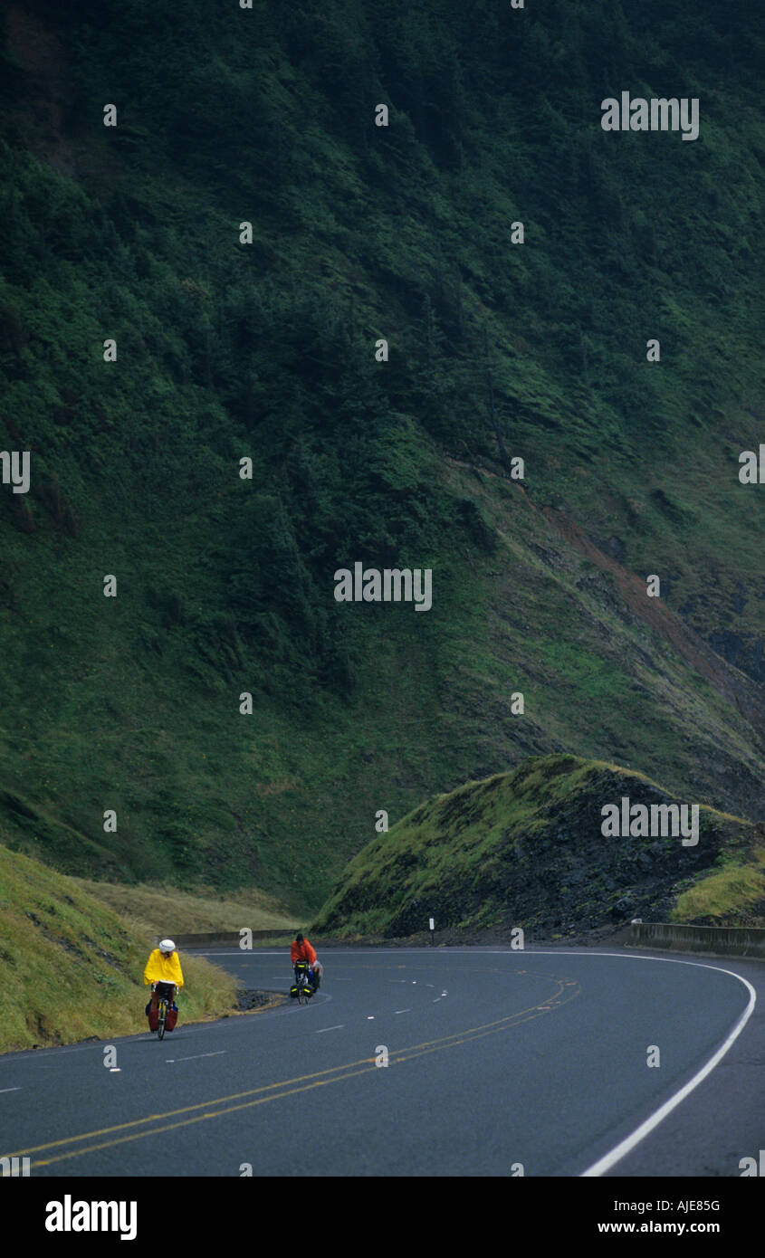 Bike riders wearing rain coats along Highway 101 southern coast Oregon ...