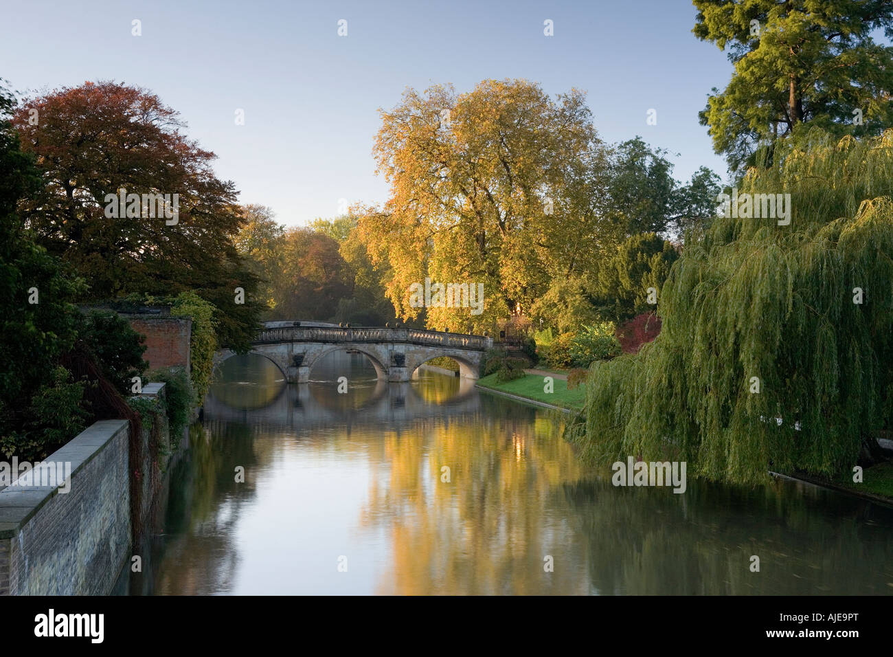 Ancient Clare bridge with autumn colours and reflections bathed in ...