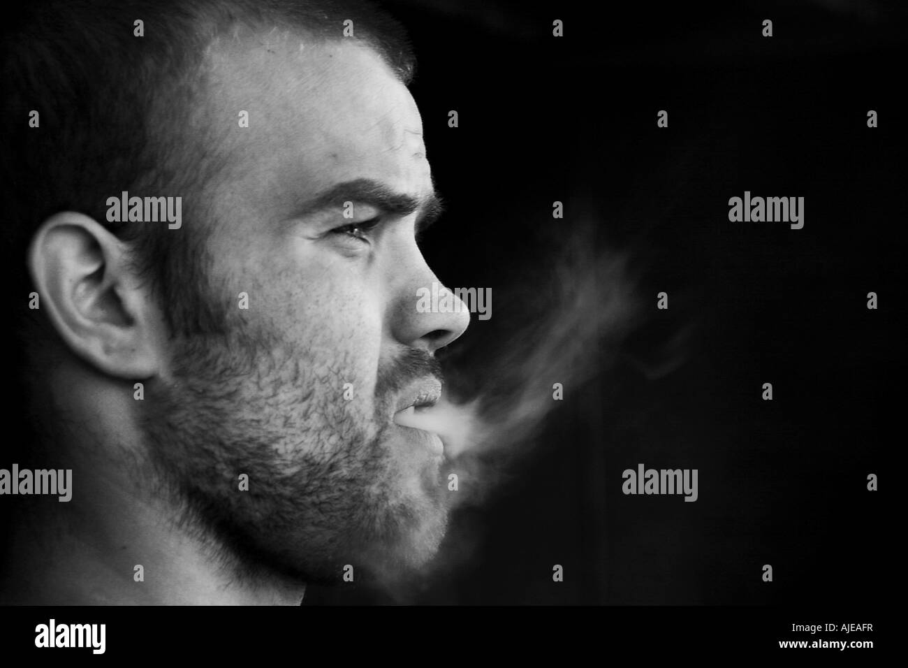 profile portrait of a young man smoking, black and white image Stock ...