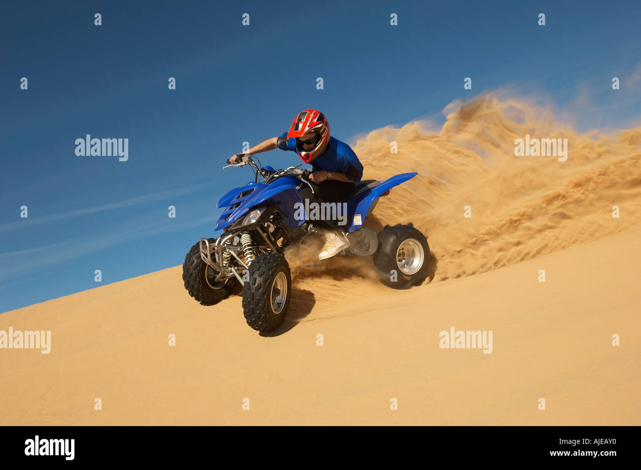 Man riding quad bike in desert Stock Photo - Alamy