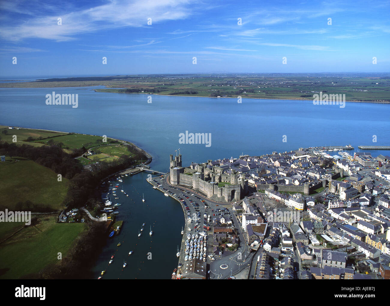 Aerial view of Caernarfon town, Castle, Seiont river estuary and Menai ...