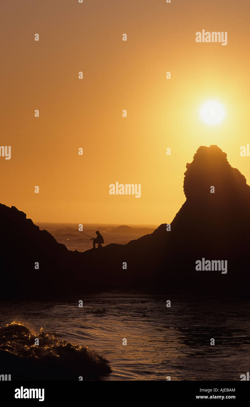 Southern Oregon Coastline with silhouetted rock formations fisherman ...