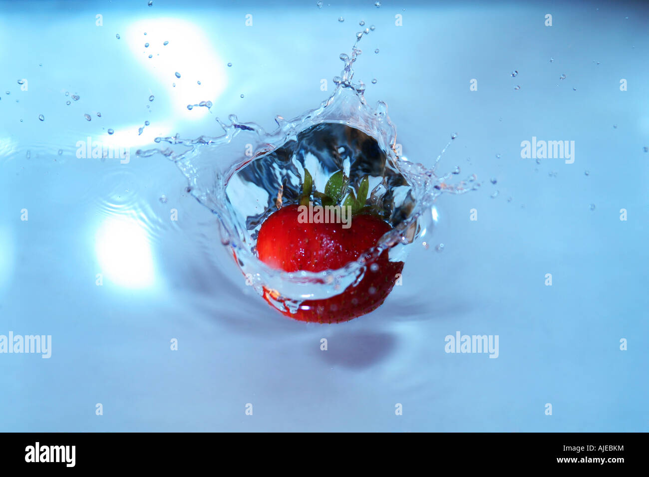 Strawberry falling into fresh ice cold water Stock Photo - Alamy
