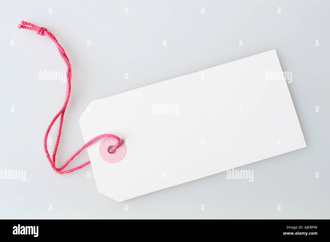 a blank white label tag with string attached Stock Photo - Alamy