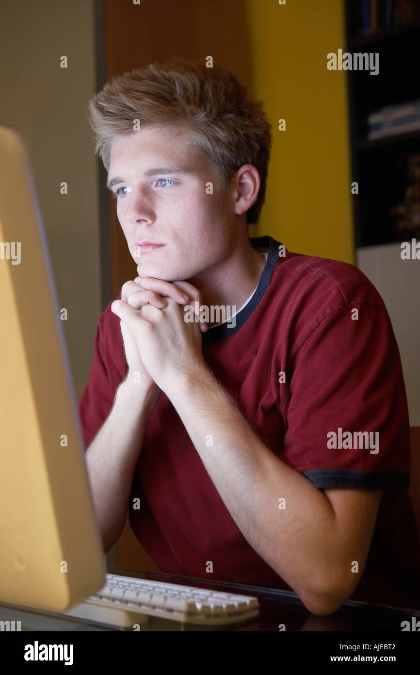 Man sitting at computer staring at screen Stock Photo - Alamy