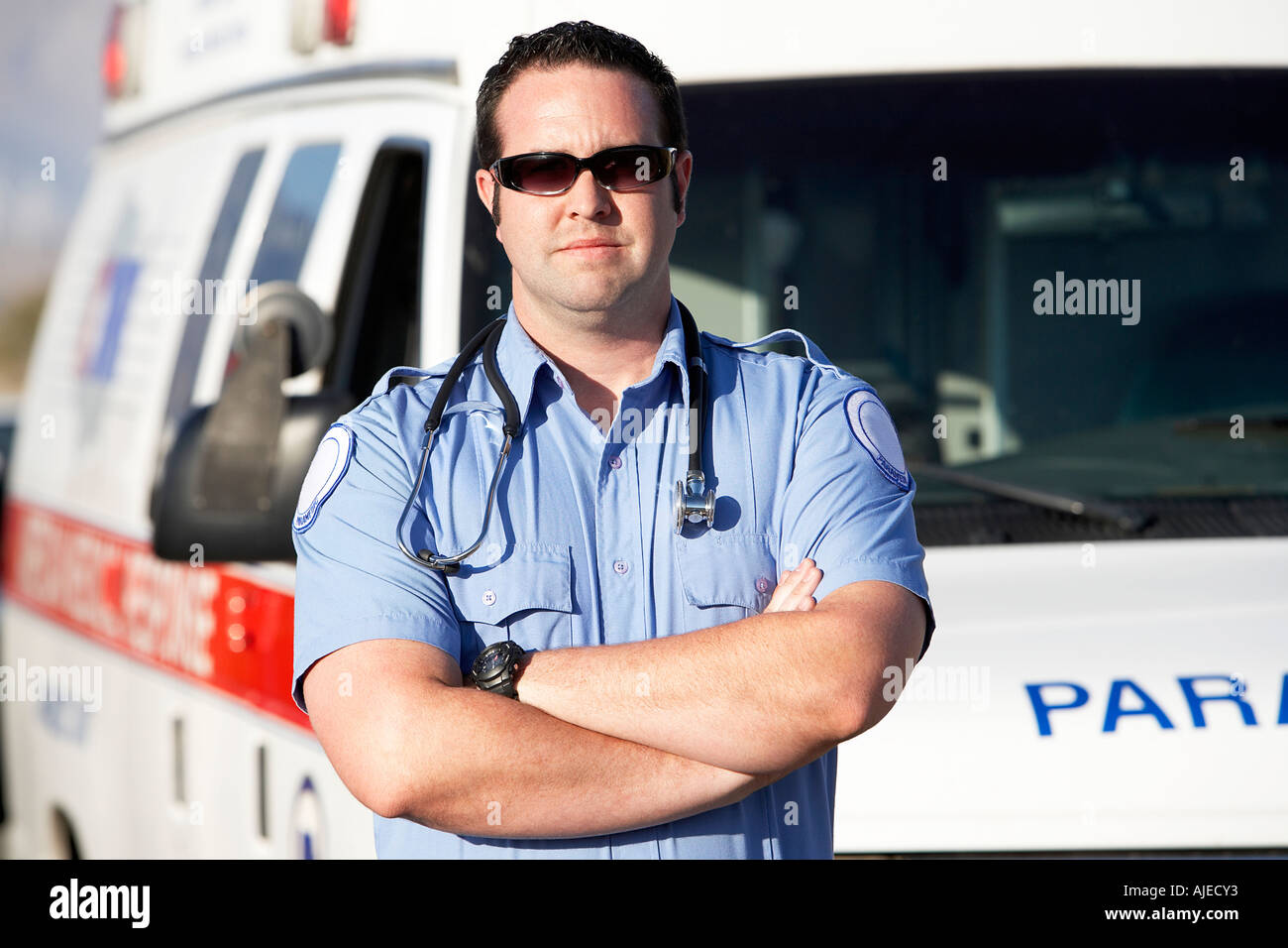Paramedic worker standing in front of ambulance, (portrait Stock Photo ...