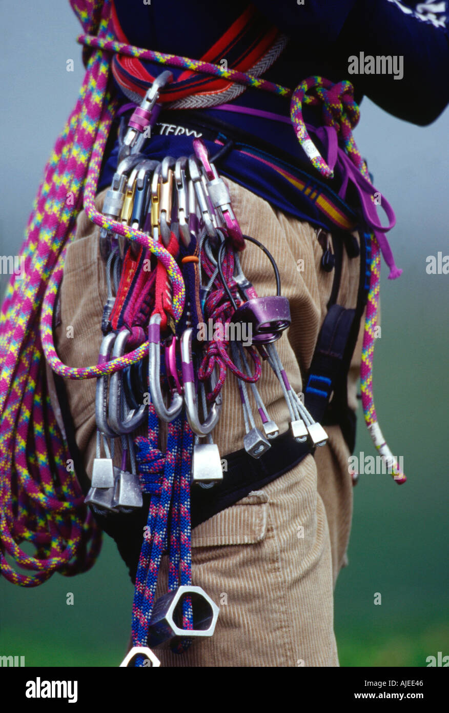 Mountaineer with ropes shackles and equipment attached to their belt ...